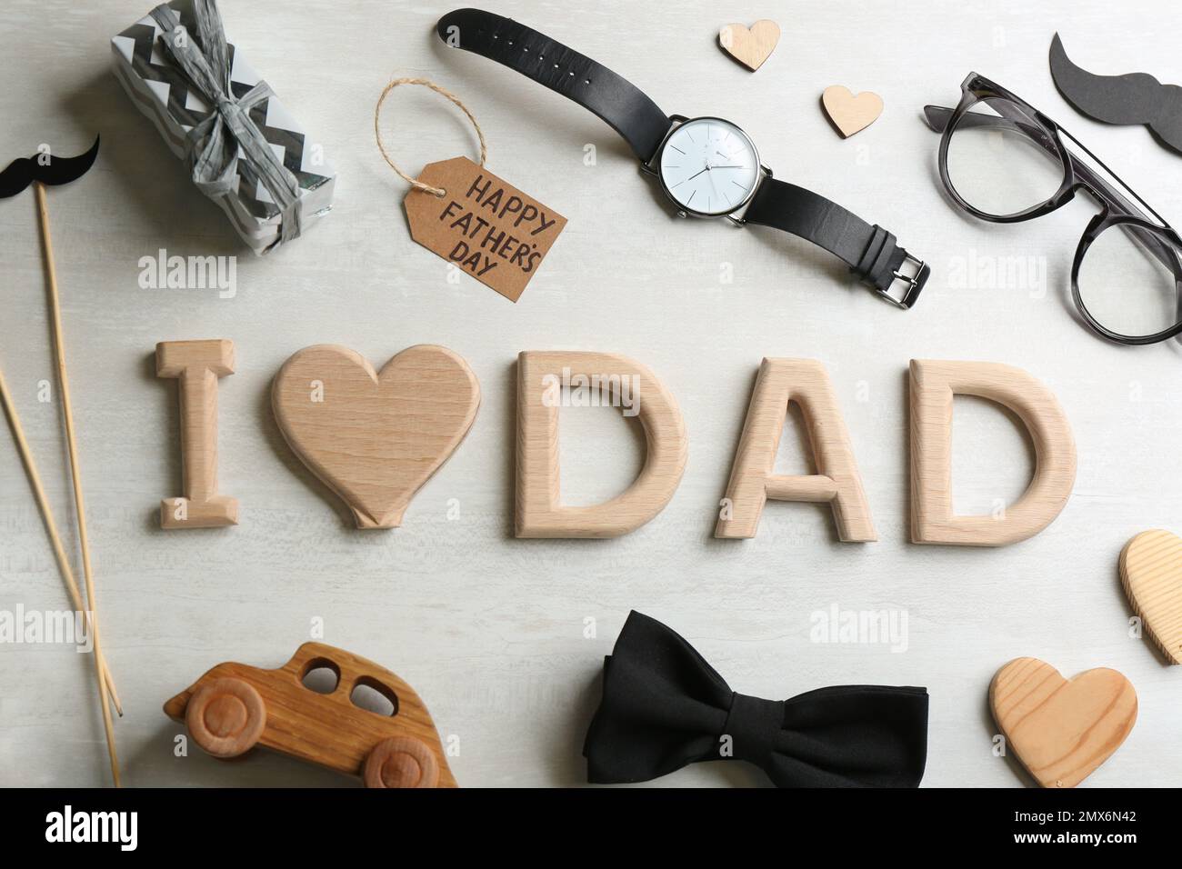 Flat lay composition with phrase I LOVE DAD on white background. Happy ...