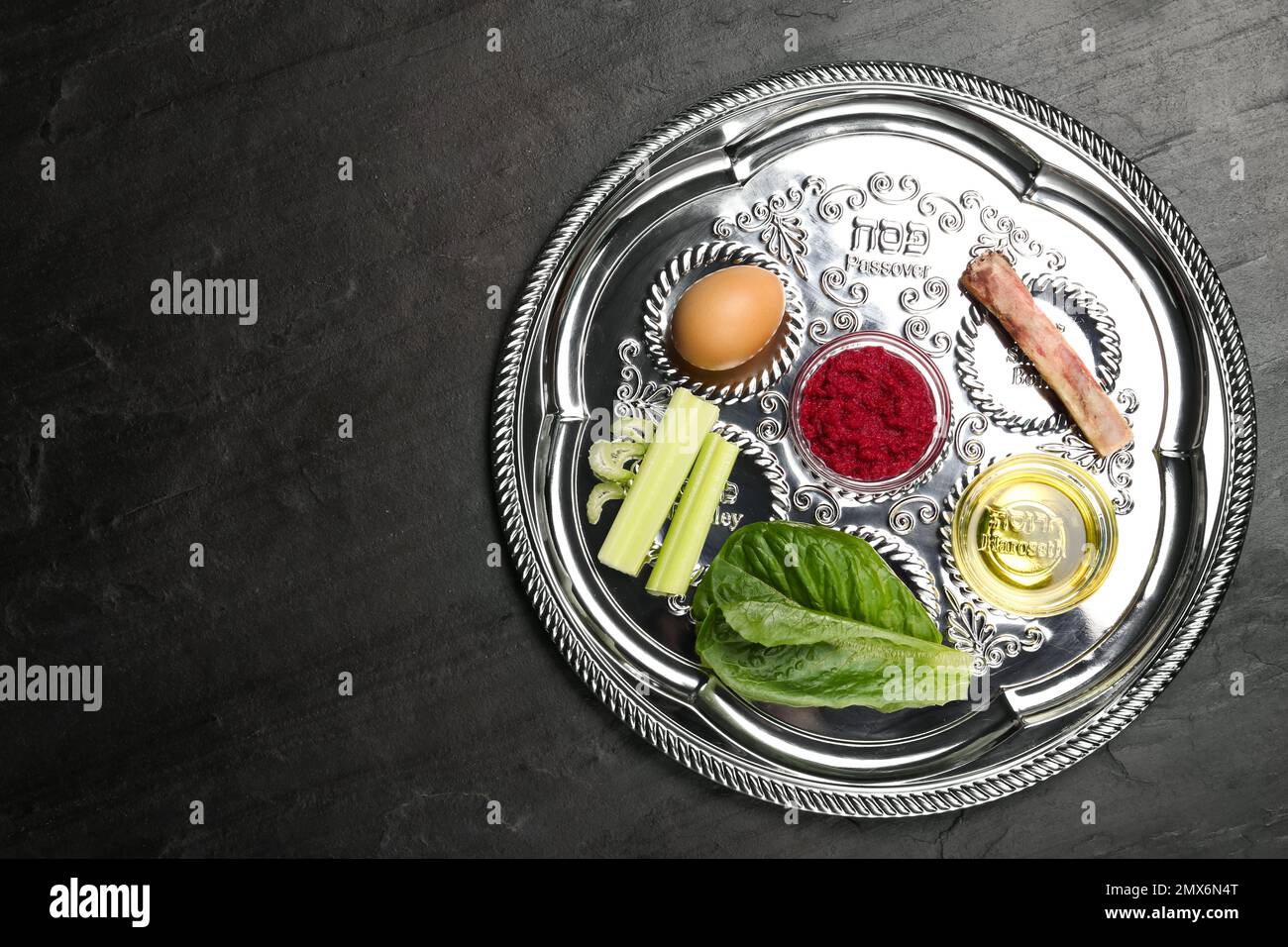 Passover Seder plate (keara) on black table, top view with space for ...