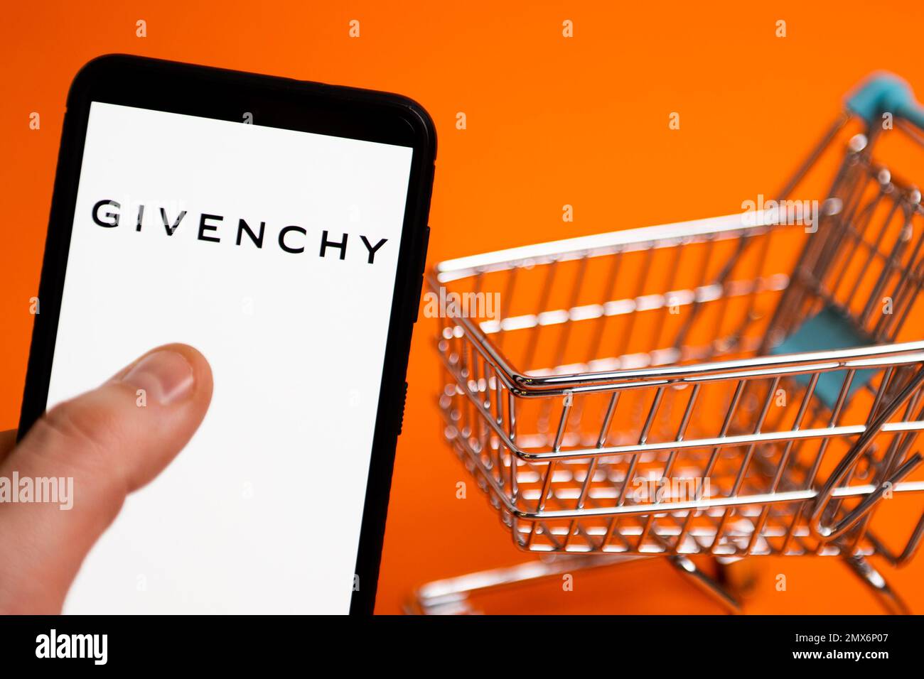 In this photo illustration a Givenchy logo seen displayed on a ...