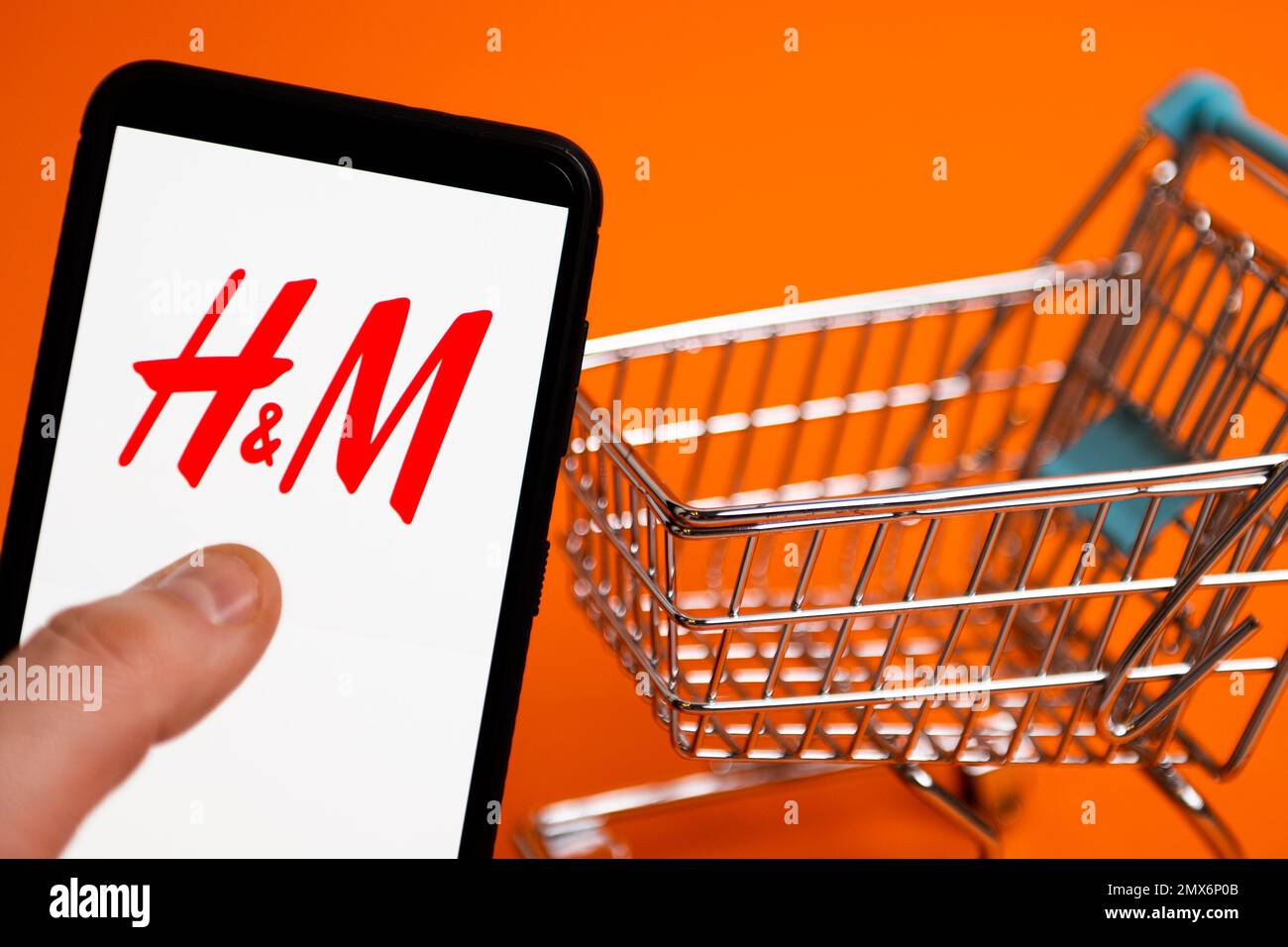 In this photo illustration a H&M logo seen displayed on a smartphone ...
