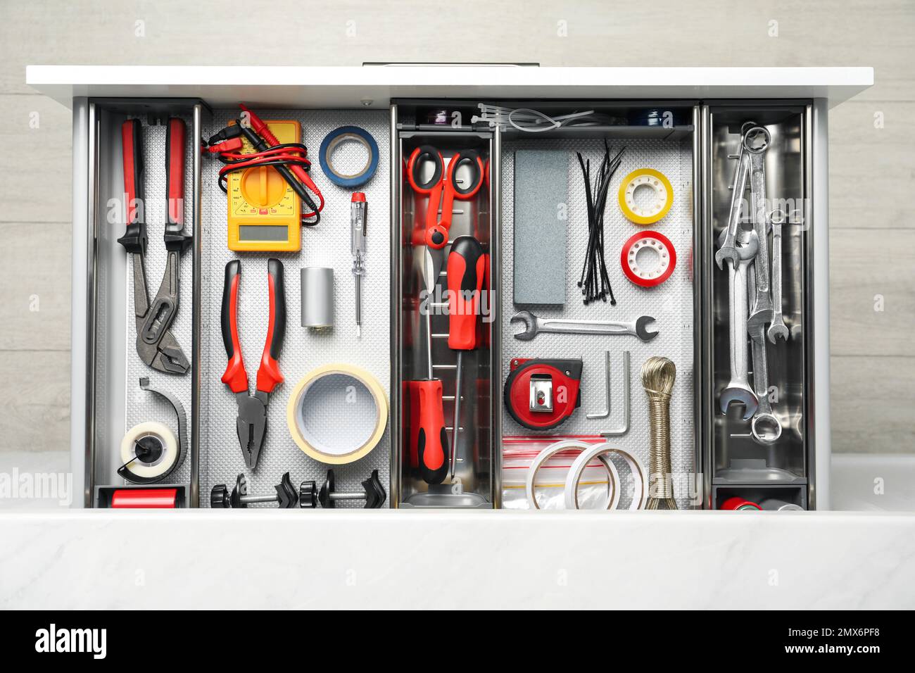 Set of instruments in open desk drawer, top view Stock Photo - Alamy