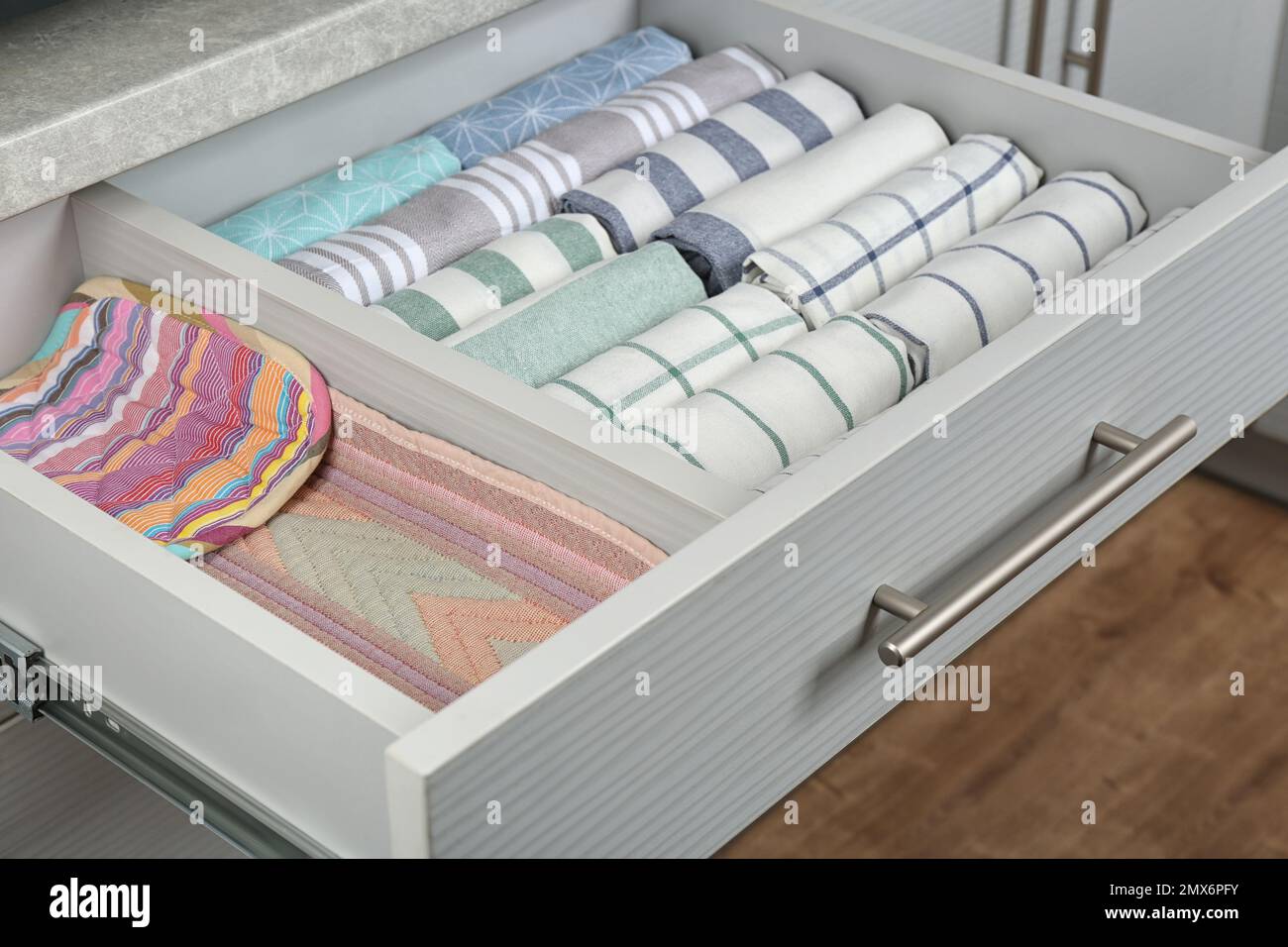 Open drawer with folded towels. Order in kitchen Stock Photo - Alamy