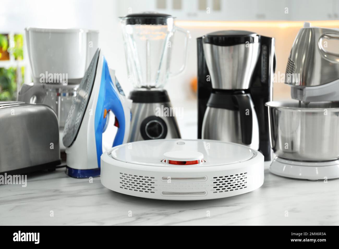 Set of modern home appliances in kitchen, focus on robotic vacuum ...
