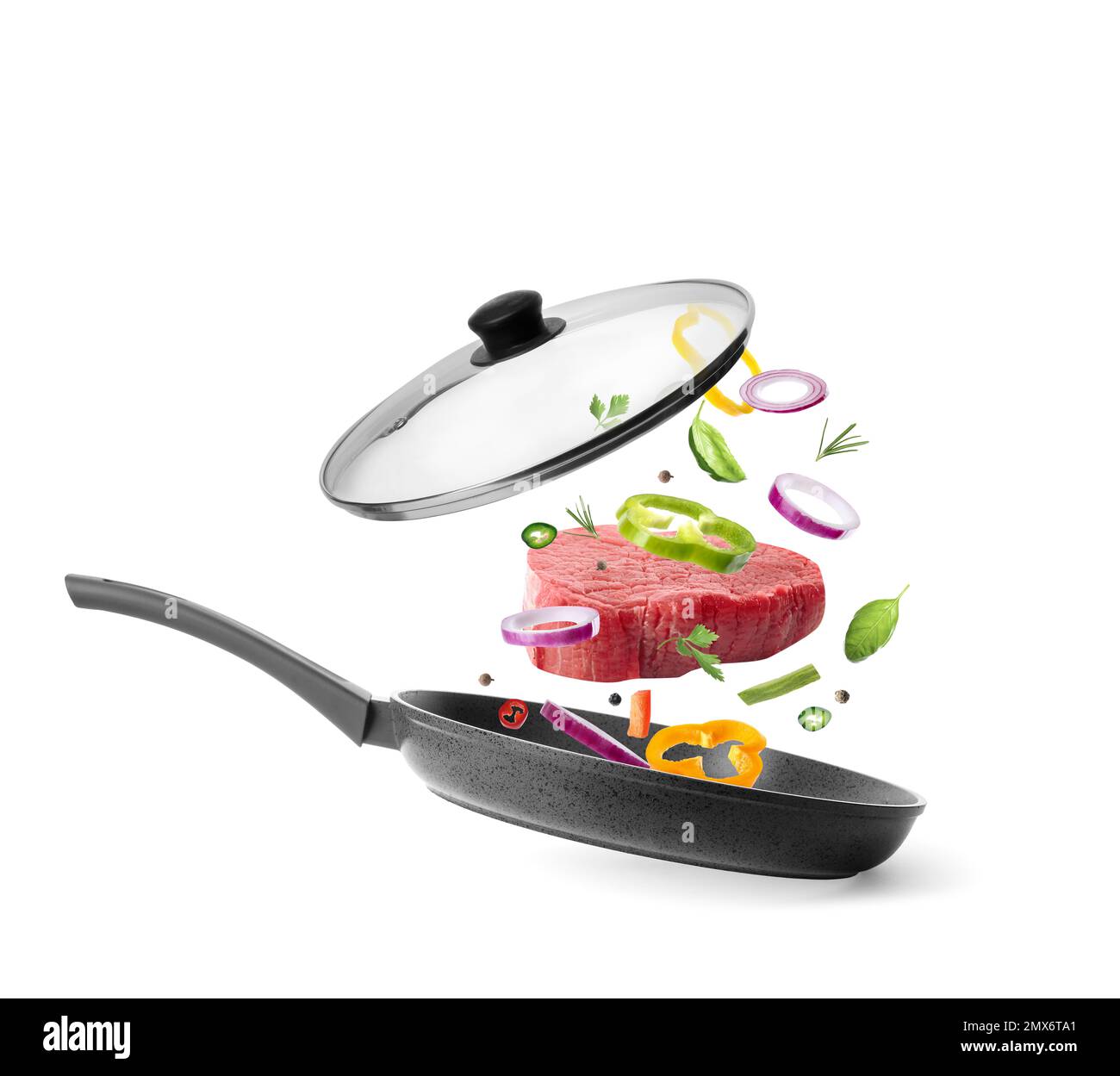 Different vegetables and beef slice falling into frying pan on white ...