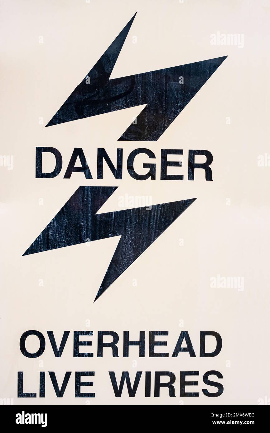 Danger overhead live wires warning sign UK Stock Photo - Alamy