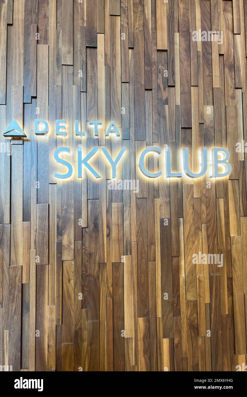 Passengers wait in line outside the Delta Sky Club at Terminal 2 at ...
