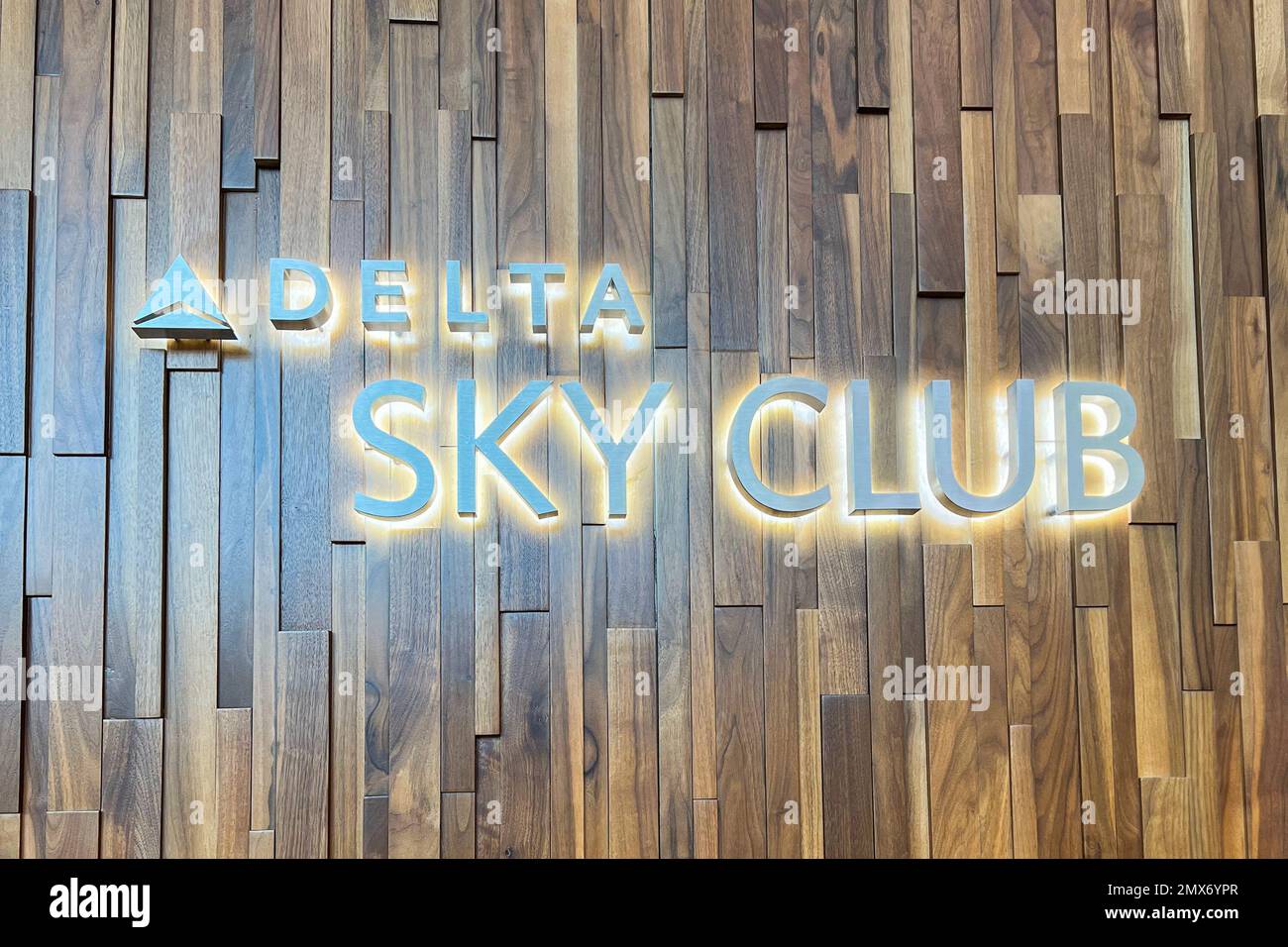 Passengers wait in line outside the Delta Sky Club at Terminal 2 at ...