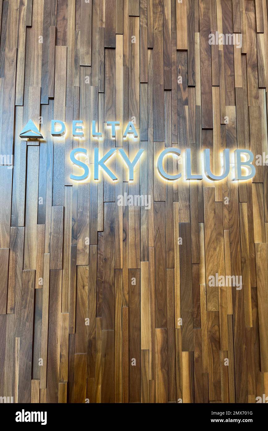 Passengers wait in line outside the Delta Sky Club at Terminal 2 at ...