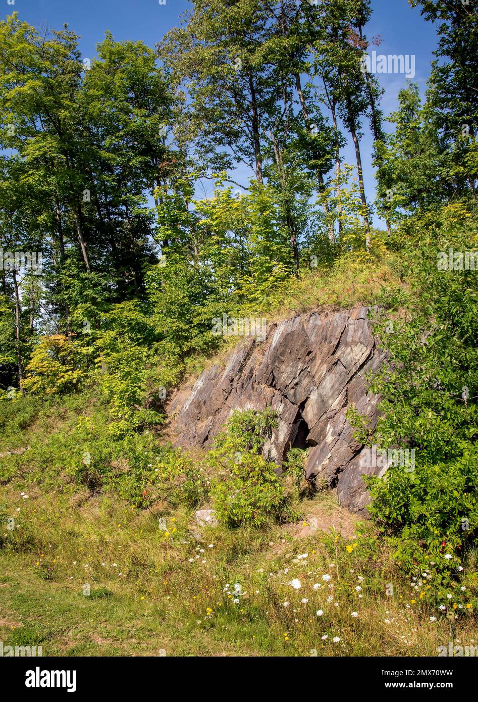 Granite exposed from soil erosion and wind on hillside Stock Photo - Alamy