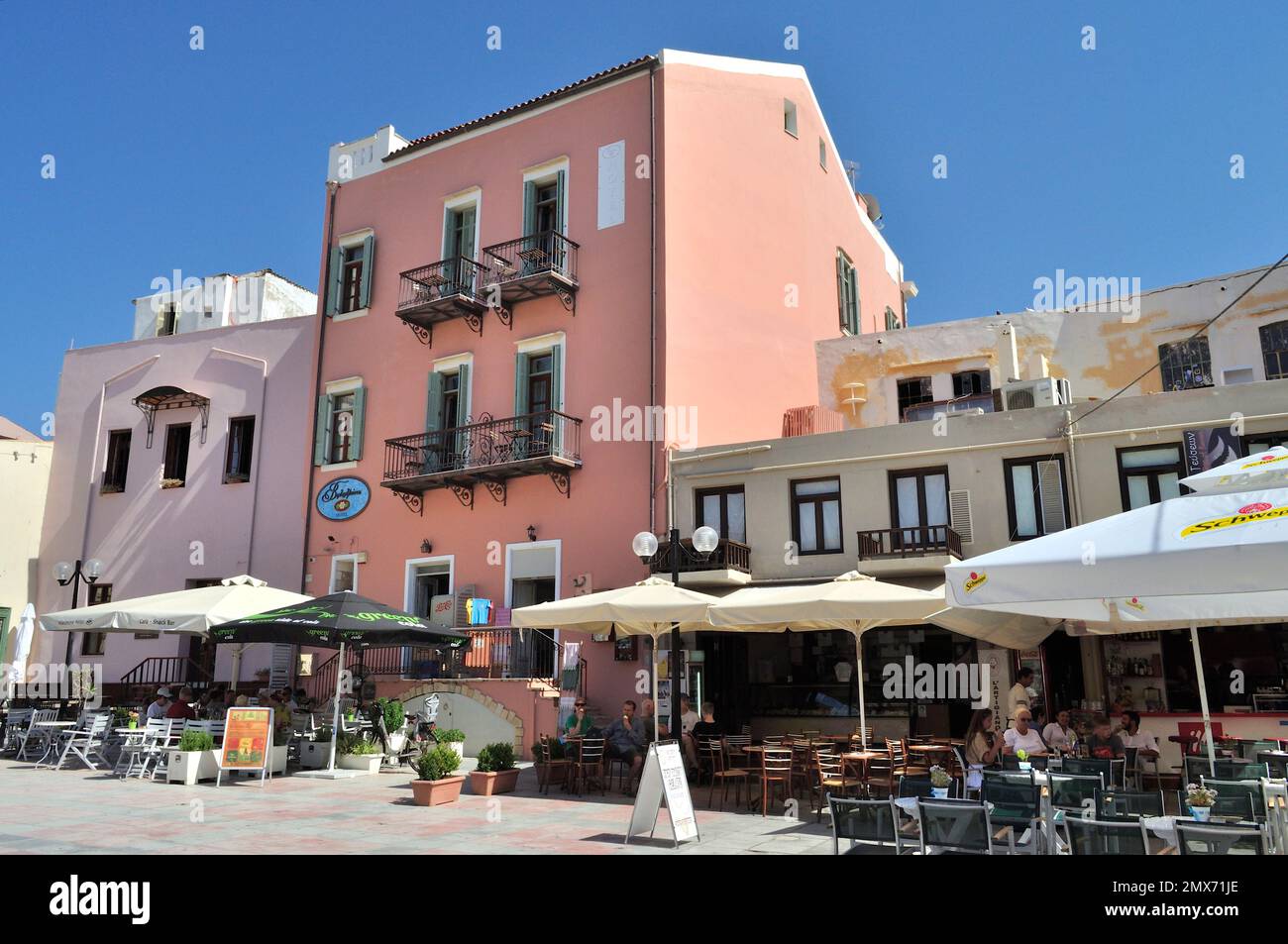 Outdoor restaurant and historic Venetian buildings in the port of the ...