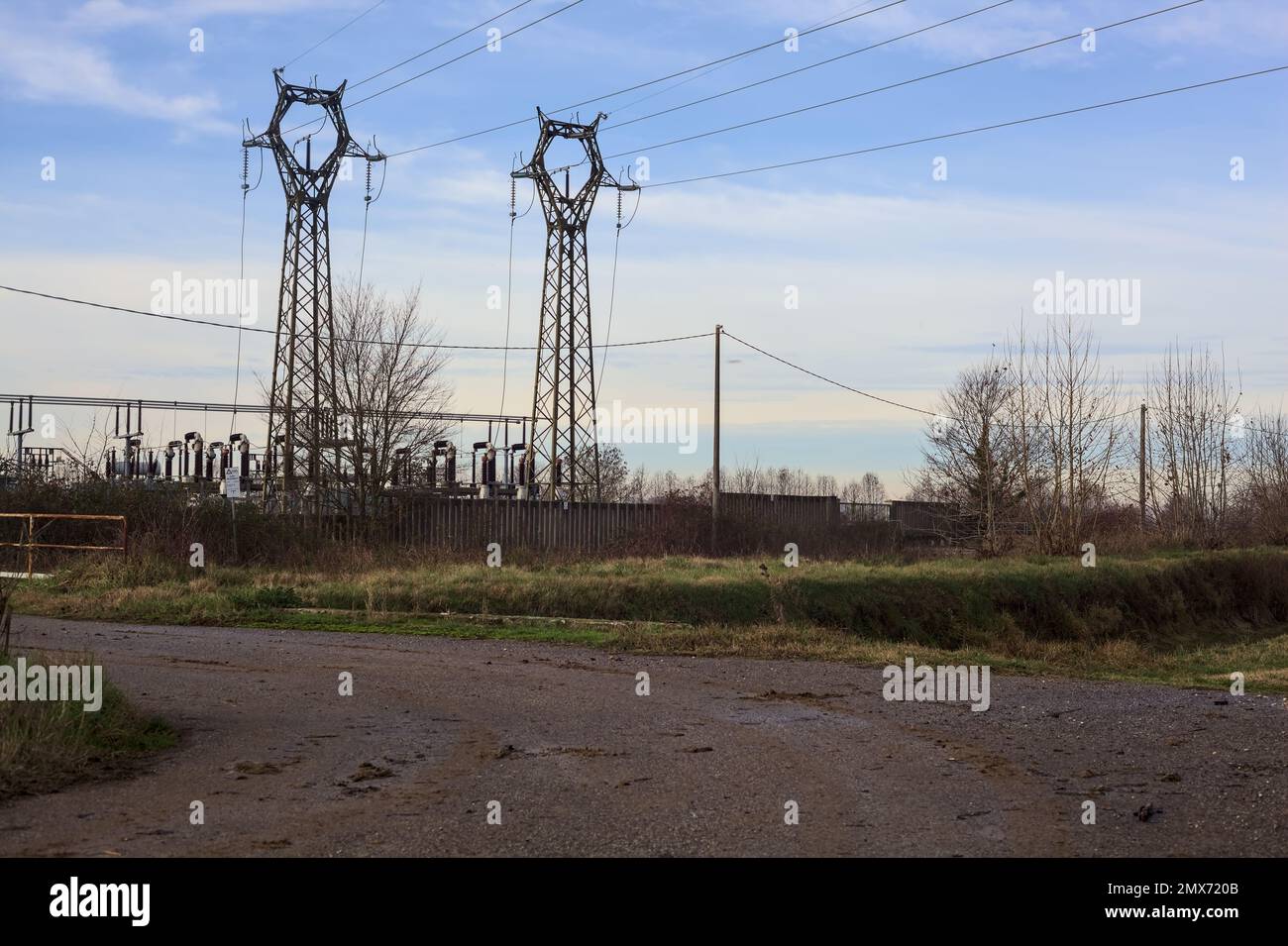 Small country road with a bridge over a stream of water next to a ...