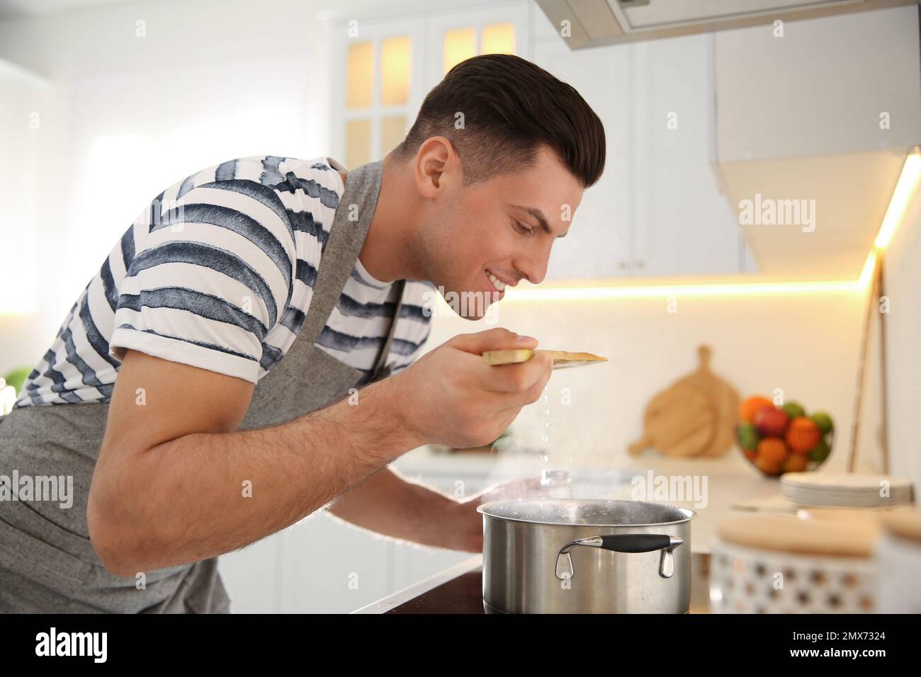 Man cooking on stove hi-res stock photography and images - Alamy