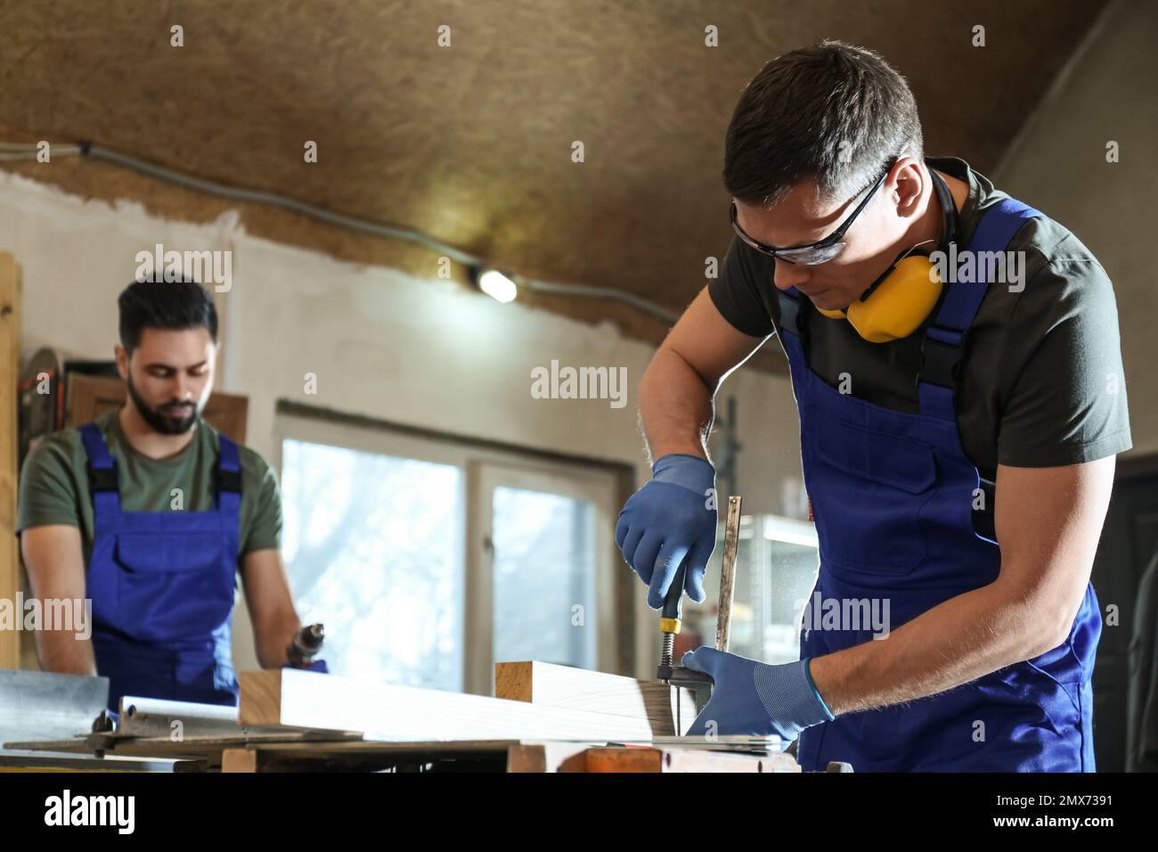 Professional carpenters working with wood in shop Stock Photo - Alamy