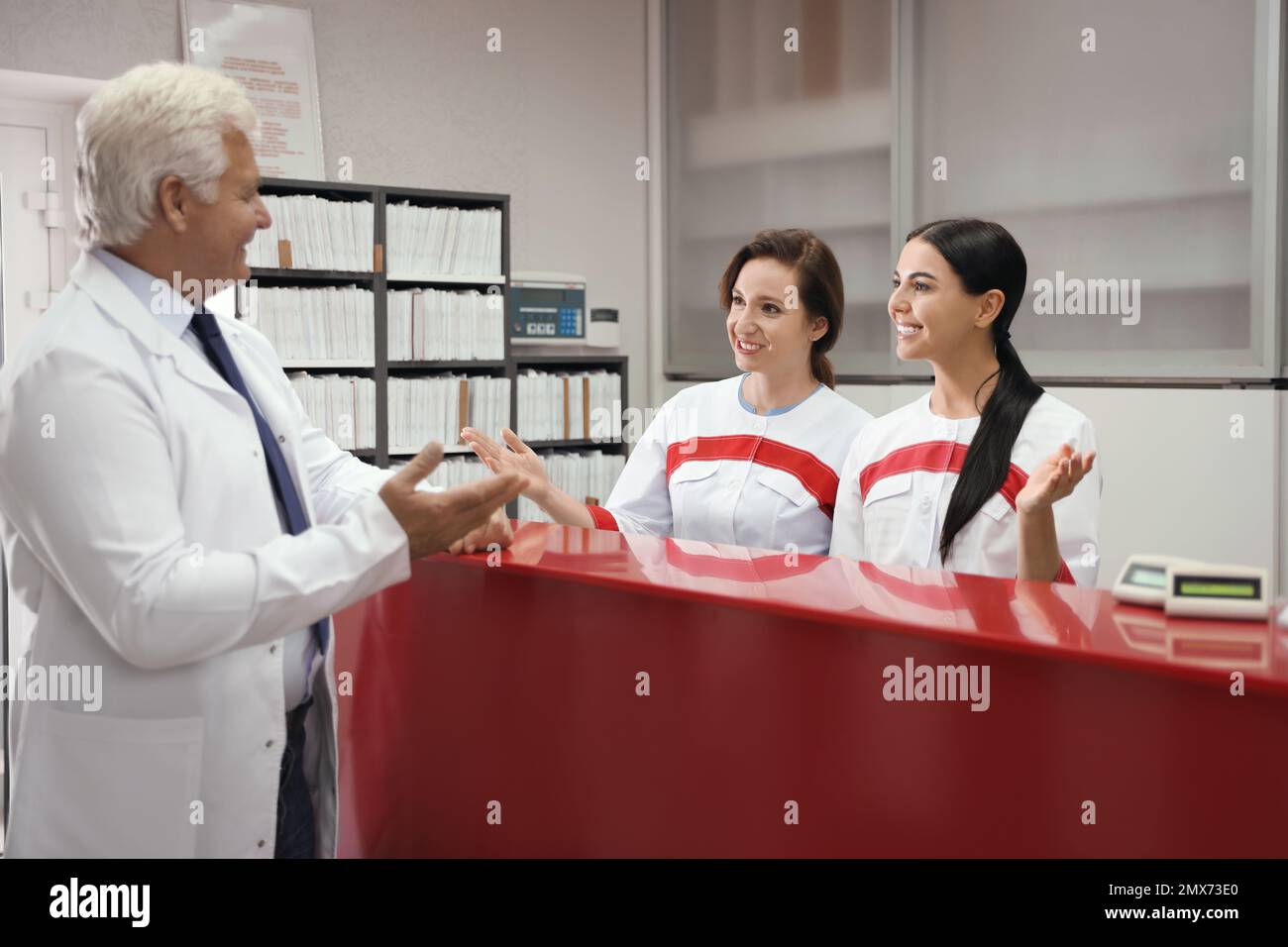 Reception of modern surgery clinic with working staff Stock Photo - Alamy