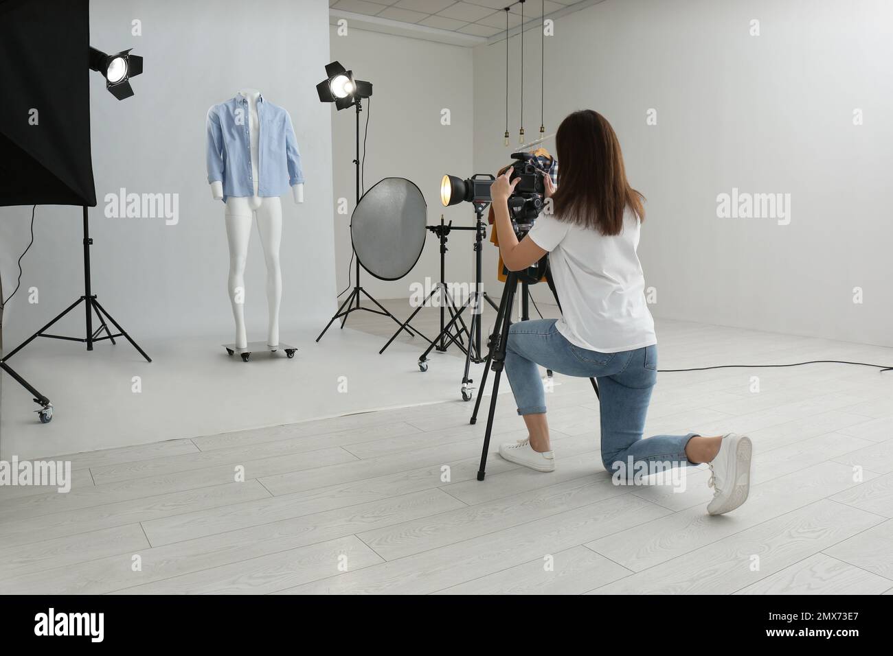 Professional photographer taking picture of ghost mannequin with modern ...