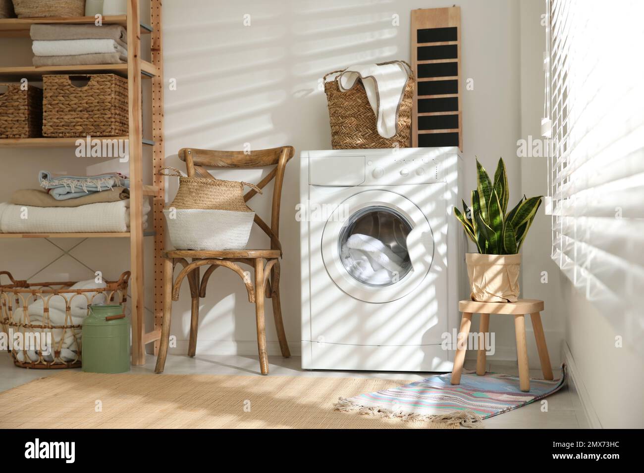 Modern washing machine in laundry room interior Stock Photo - Alamy