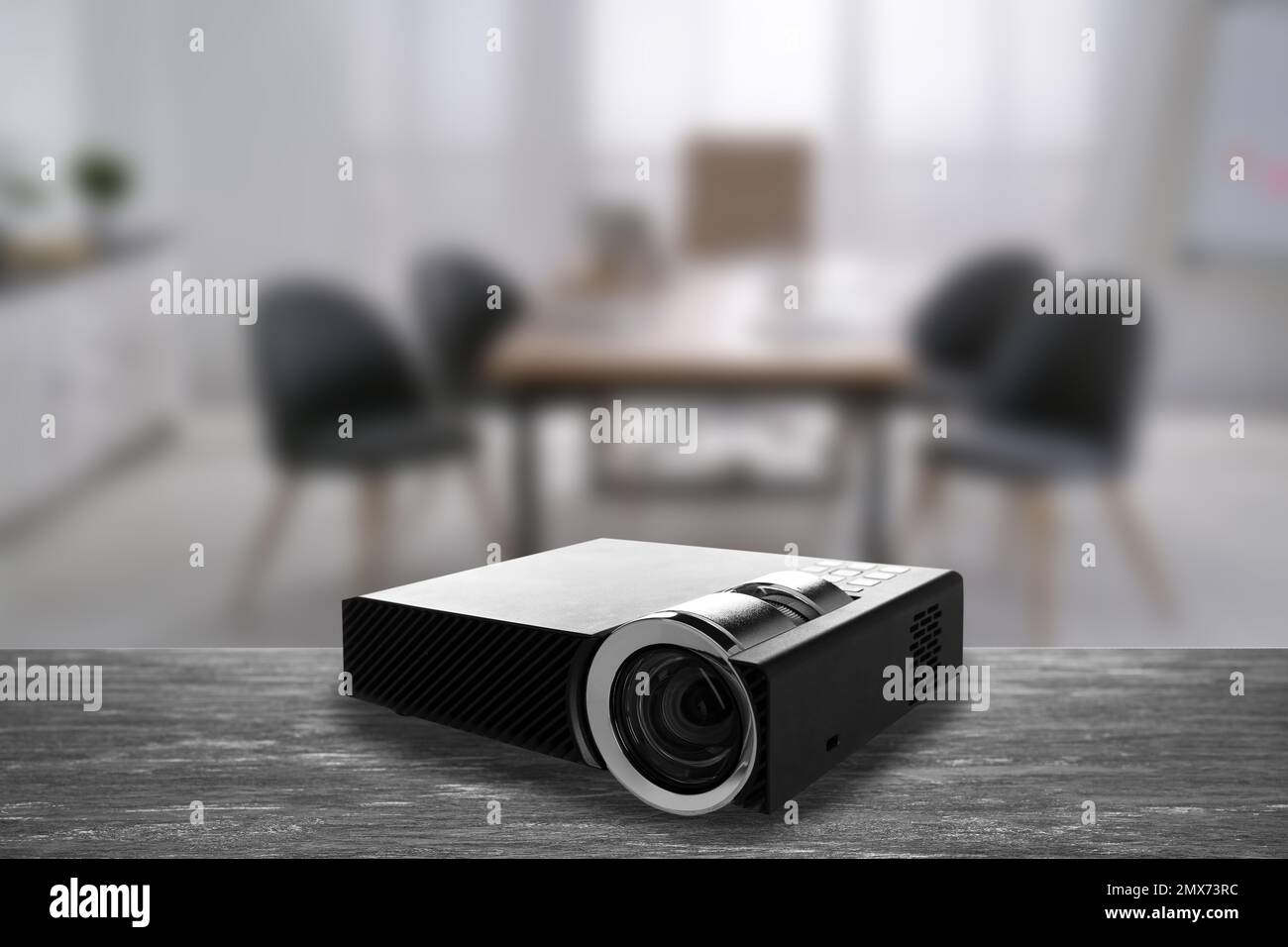 Modern video projector and blurred conference room on background Stock ...