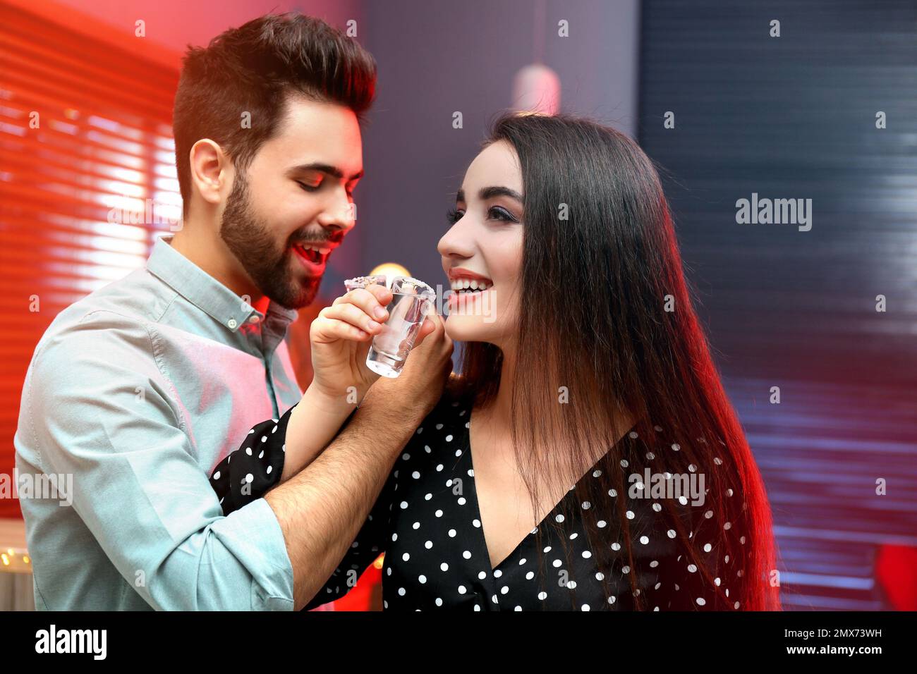Young couple drinking Mexican Tequila shots in bar Stock Photo - Alamy