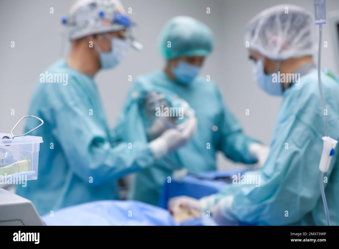 Blurred view of doctors operating patient in surgery room Stock Photo ...