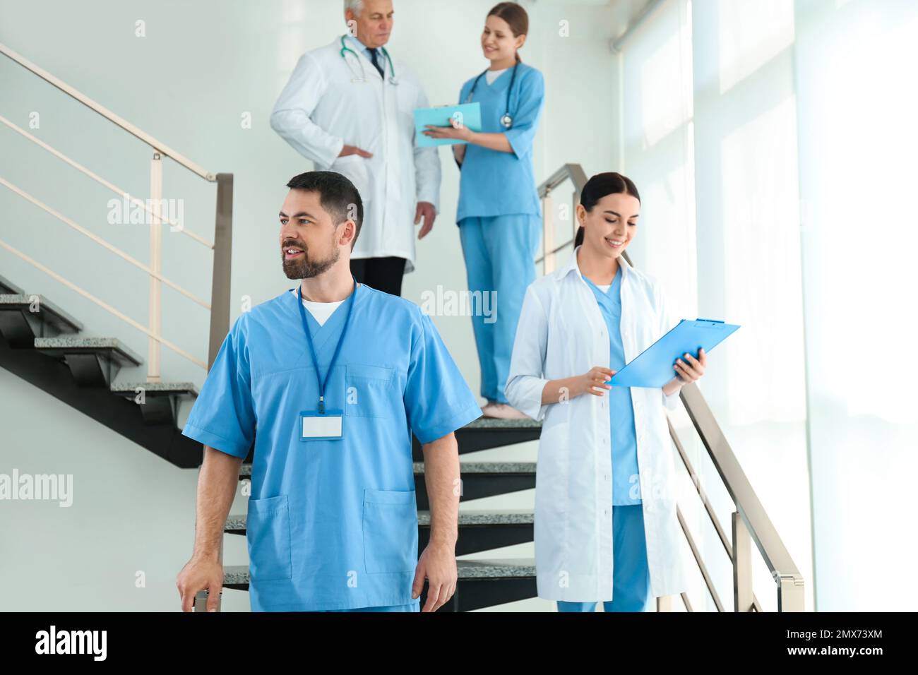 Group of doctors walking in clinic. Medical service Stock Photo - Alamy