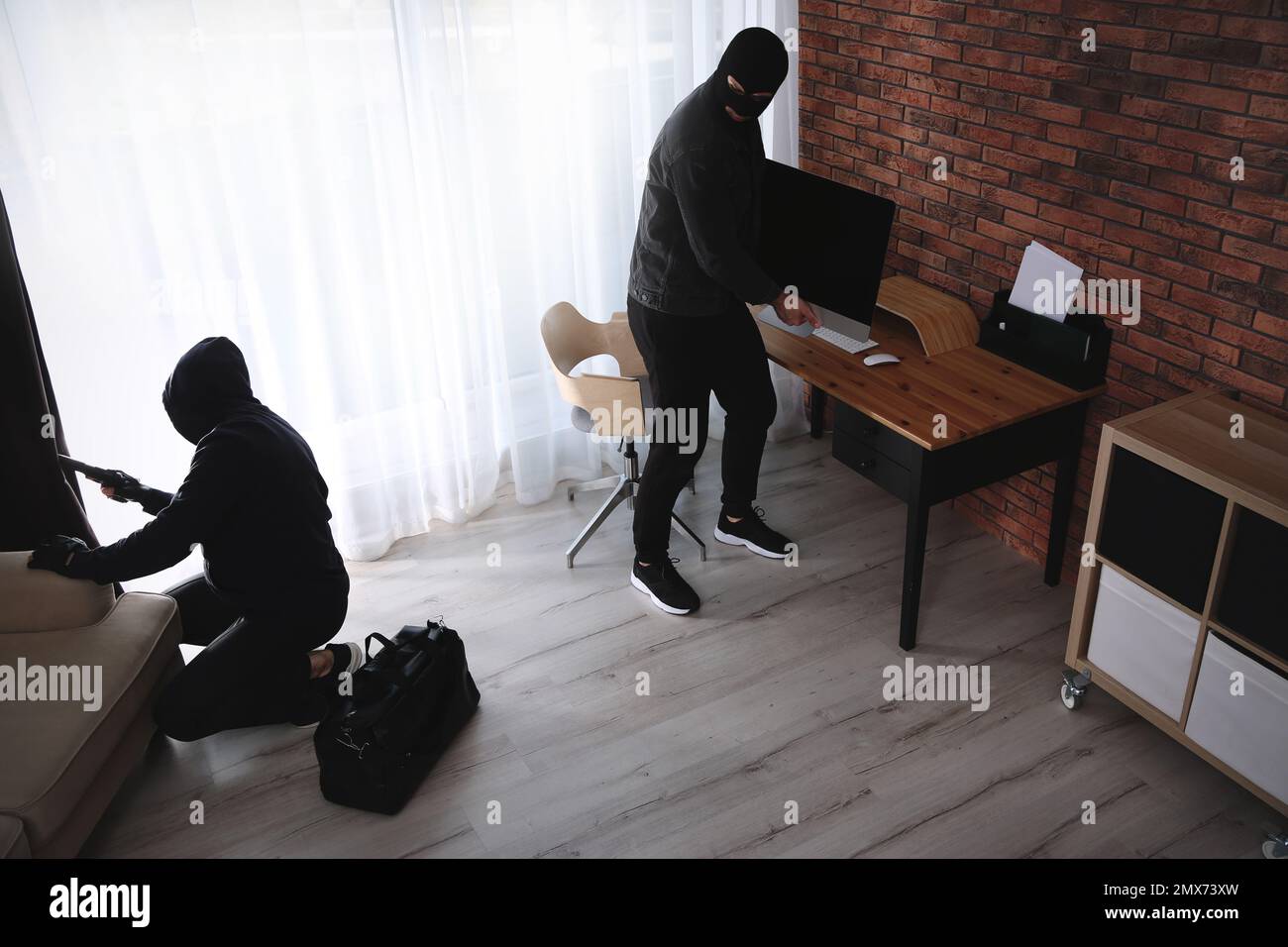 Dangerous masked criminals with weapon stealing computer from house ...