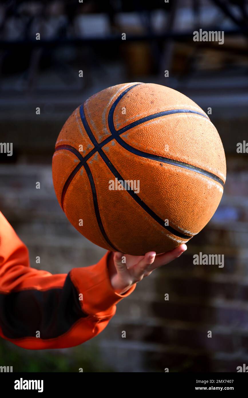 Basketball shows worn places where it has been dribbled on concrete ...