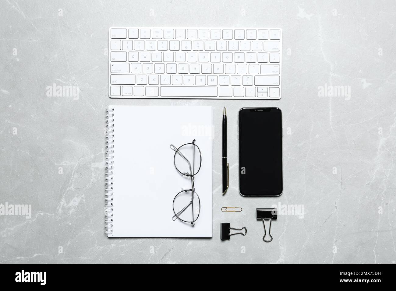 Flat lay composition with computer keyboard and smartphone on marble ...