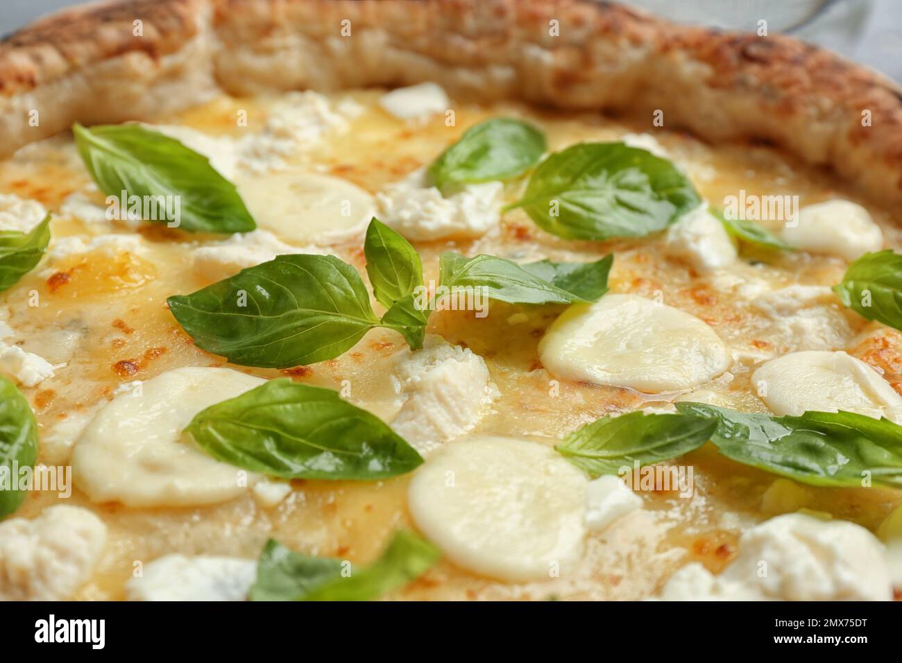 Delicious hot cheese pizza with basil on table, closeup Stock Photo - Alamy