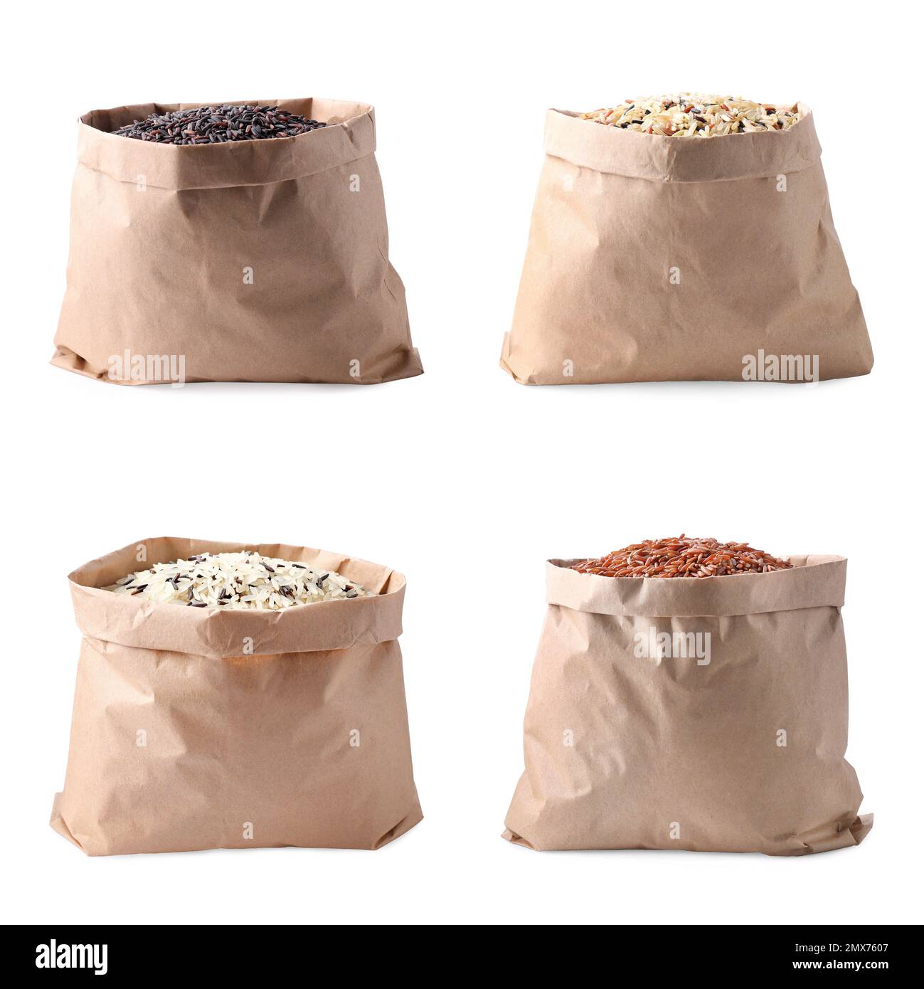 Set with different types of rice in paper bags on white background ...