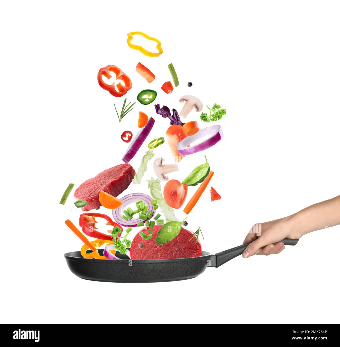 Woman holding nonstick frying pan with falling beef slices and ...