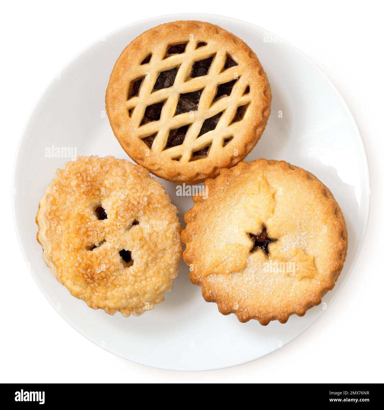 Three types of all butter mince pies on white ceramic plate isolated on ...