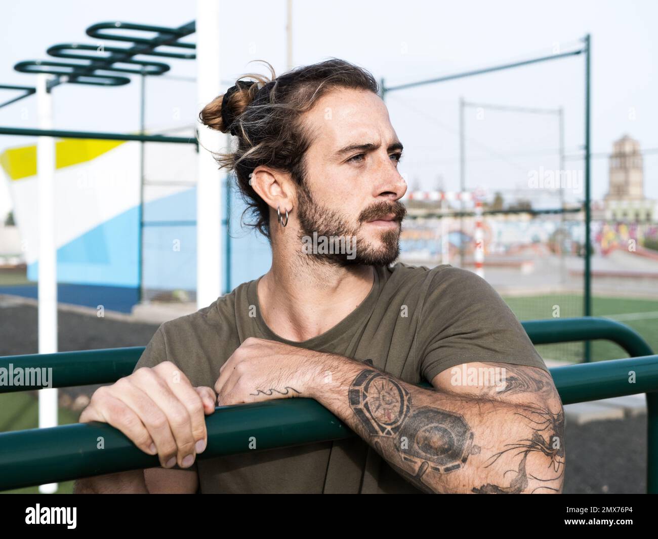 Portrait of a caucasian athlete man with long hair and beard outdoor at ...