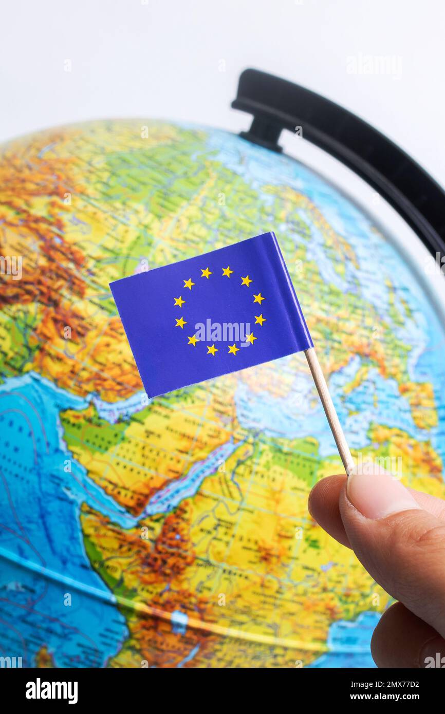 EU flag on a background of a globe with a map Stock Photo - Alamy