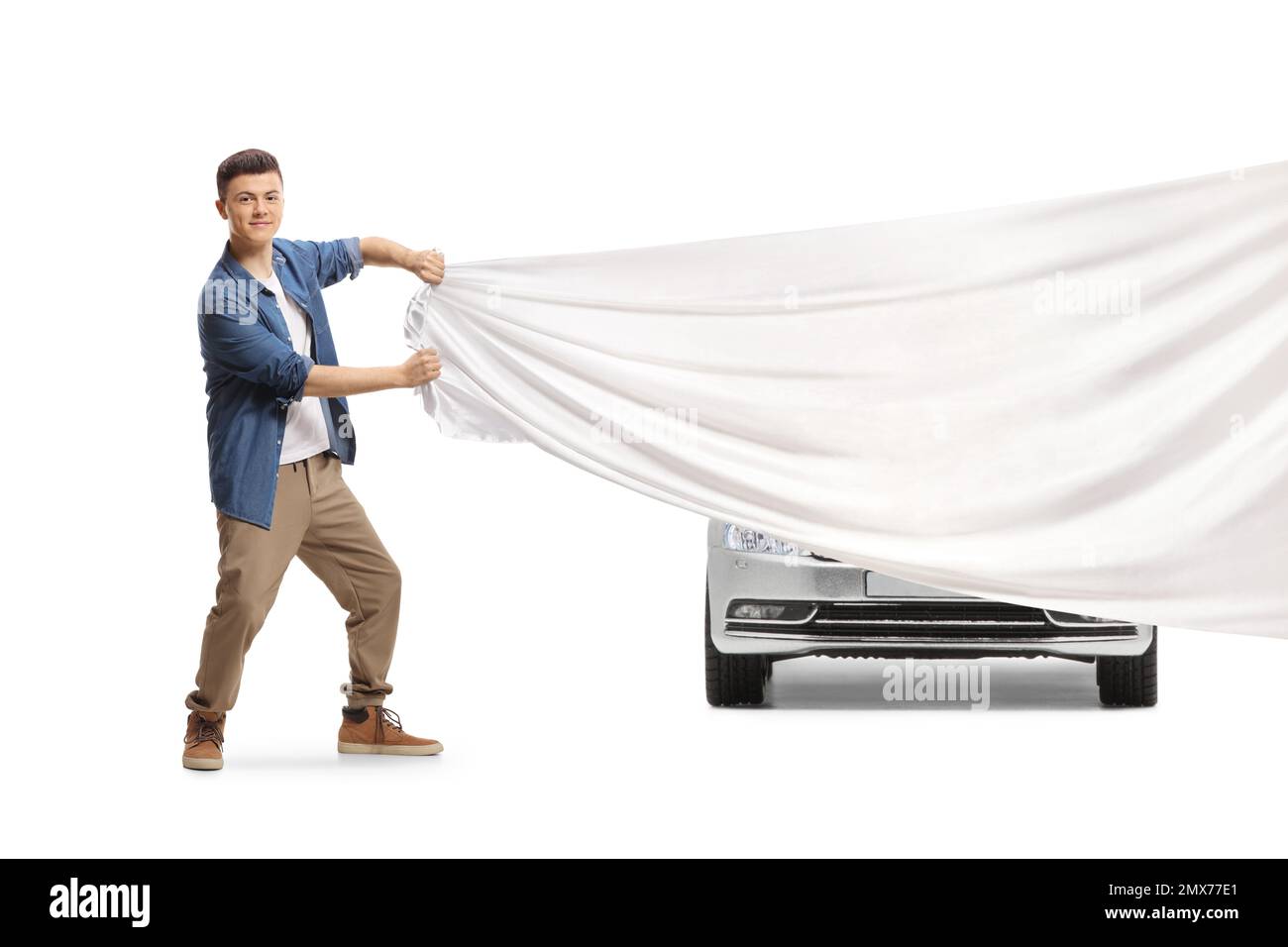 Full length portrait of a young casual man hiding a car with a big ...