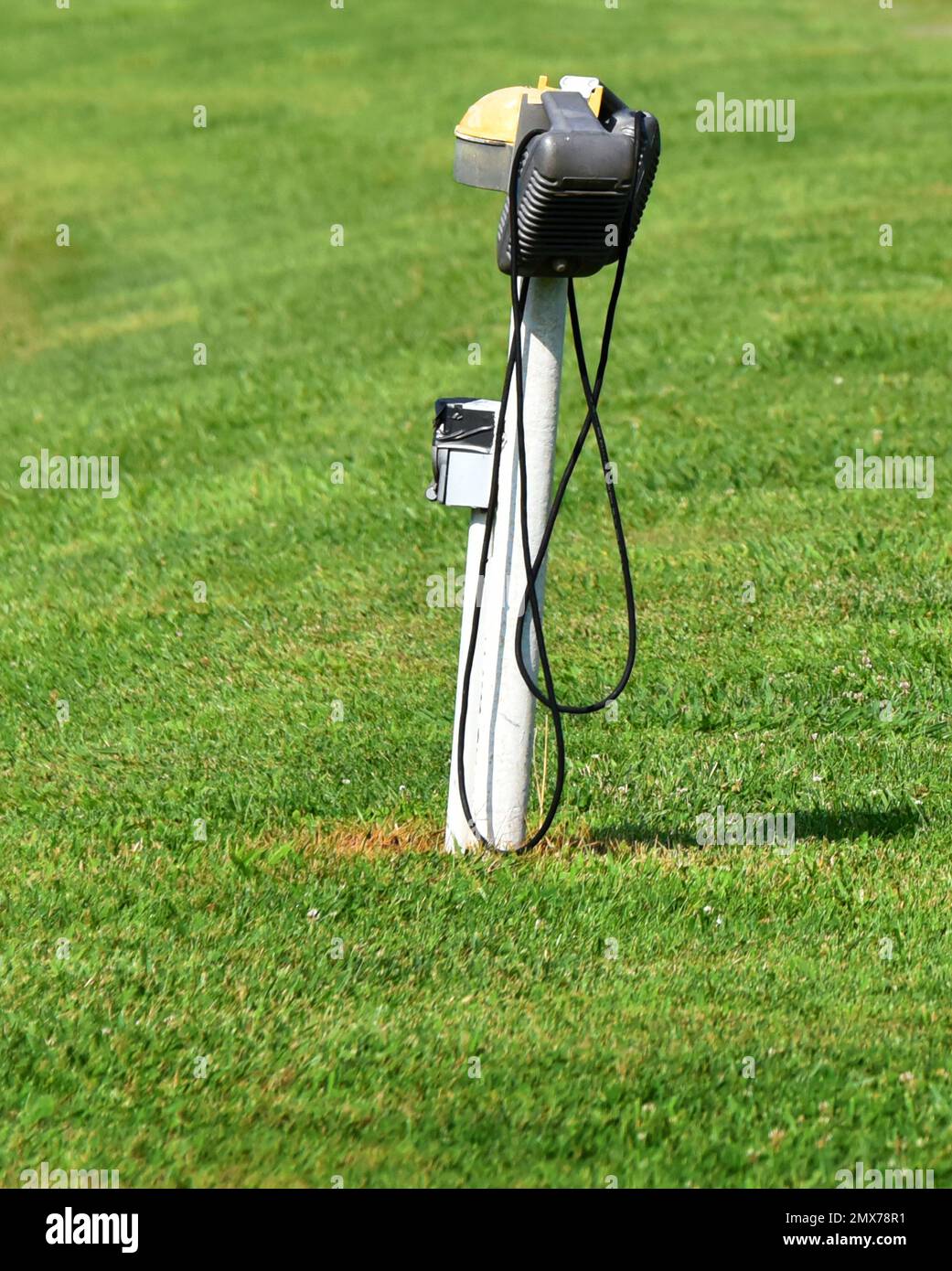 Pair of vintage speakers hang from pole in the parking area for a drive ...