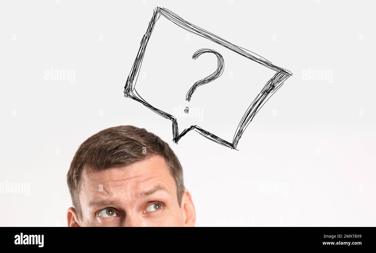 Emotional man with drawing of question mark on white background Stock ...