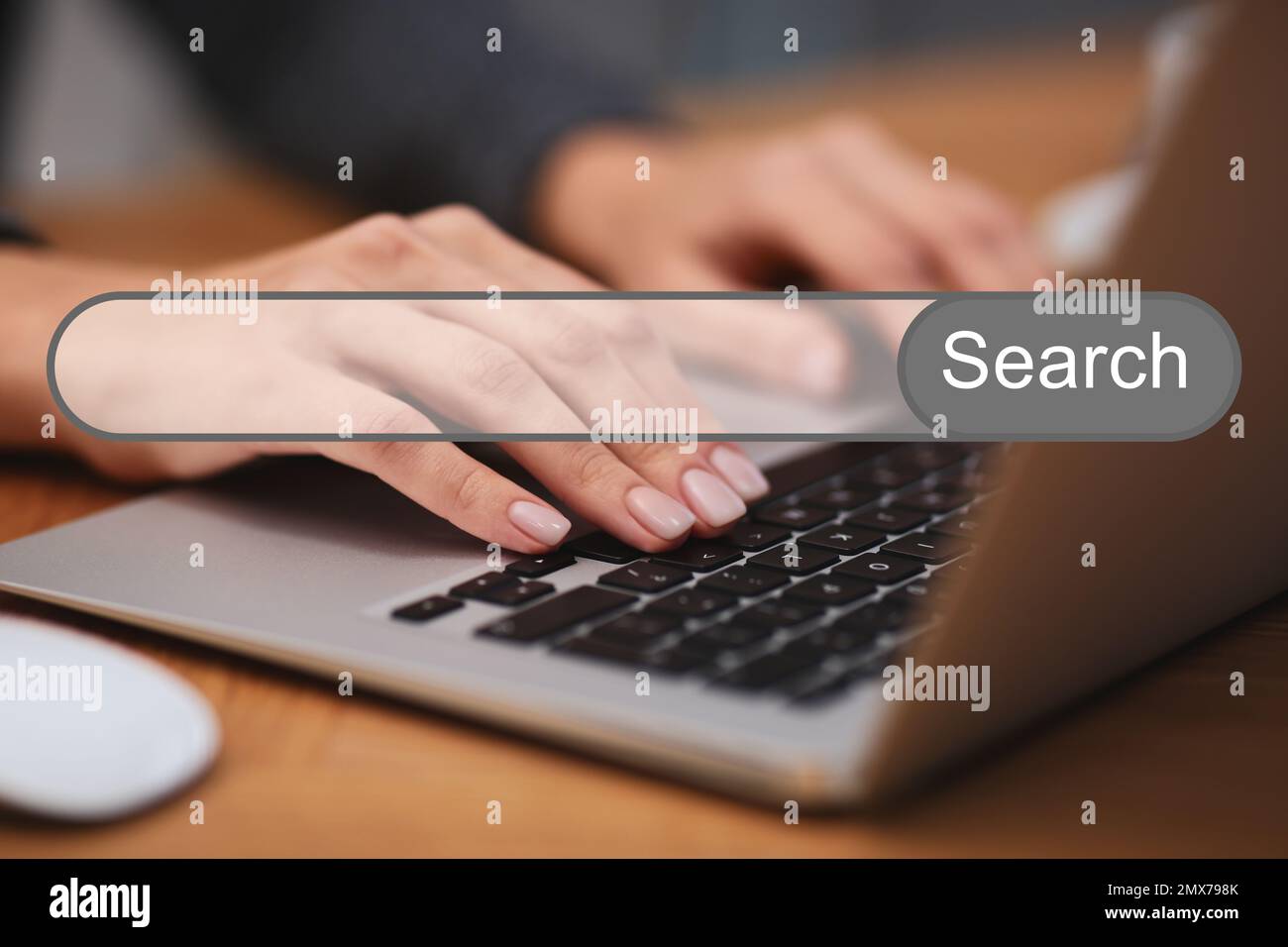 Search bar of internet browser and woman working with laptop at table ...