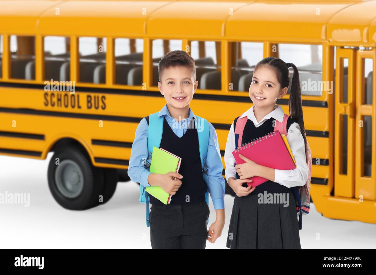 Children with backpacks near yellow school bus. Transport for students ...
