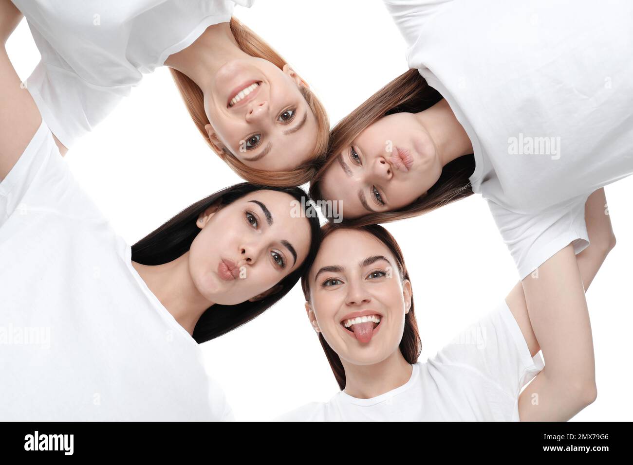 Beautiful young ladies hugging on white background, bottom view. Women ...