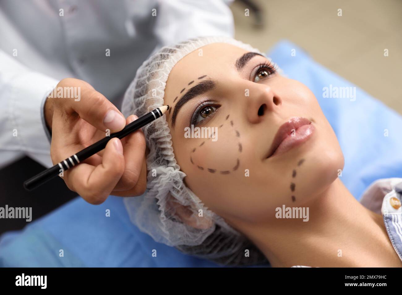 Doctor preparing female patient for cosmetic surgery in clinic Stock ...
