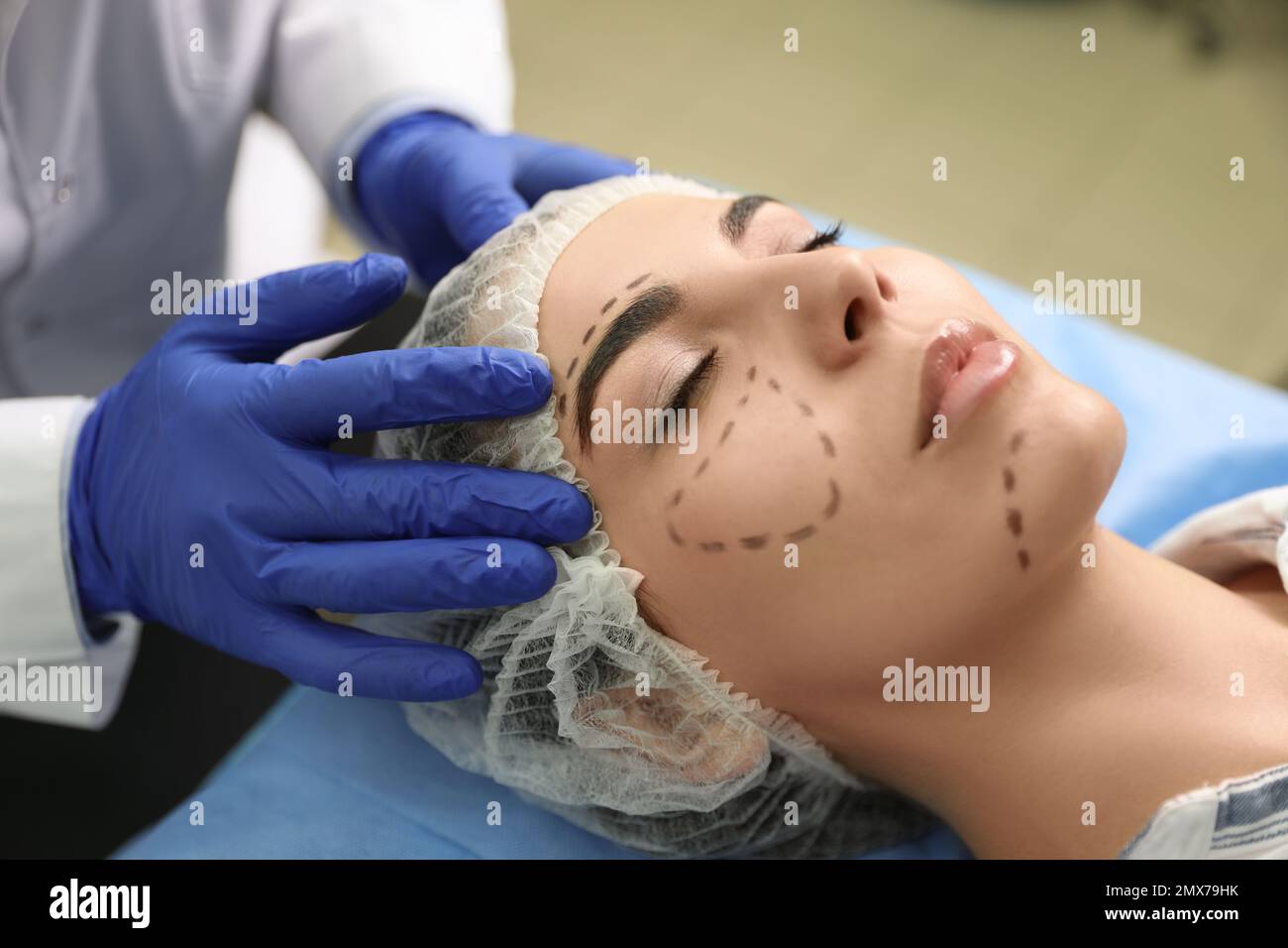 Doctor preparing female patient for cosmetic surgery in clinic Stock ...