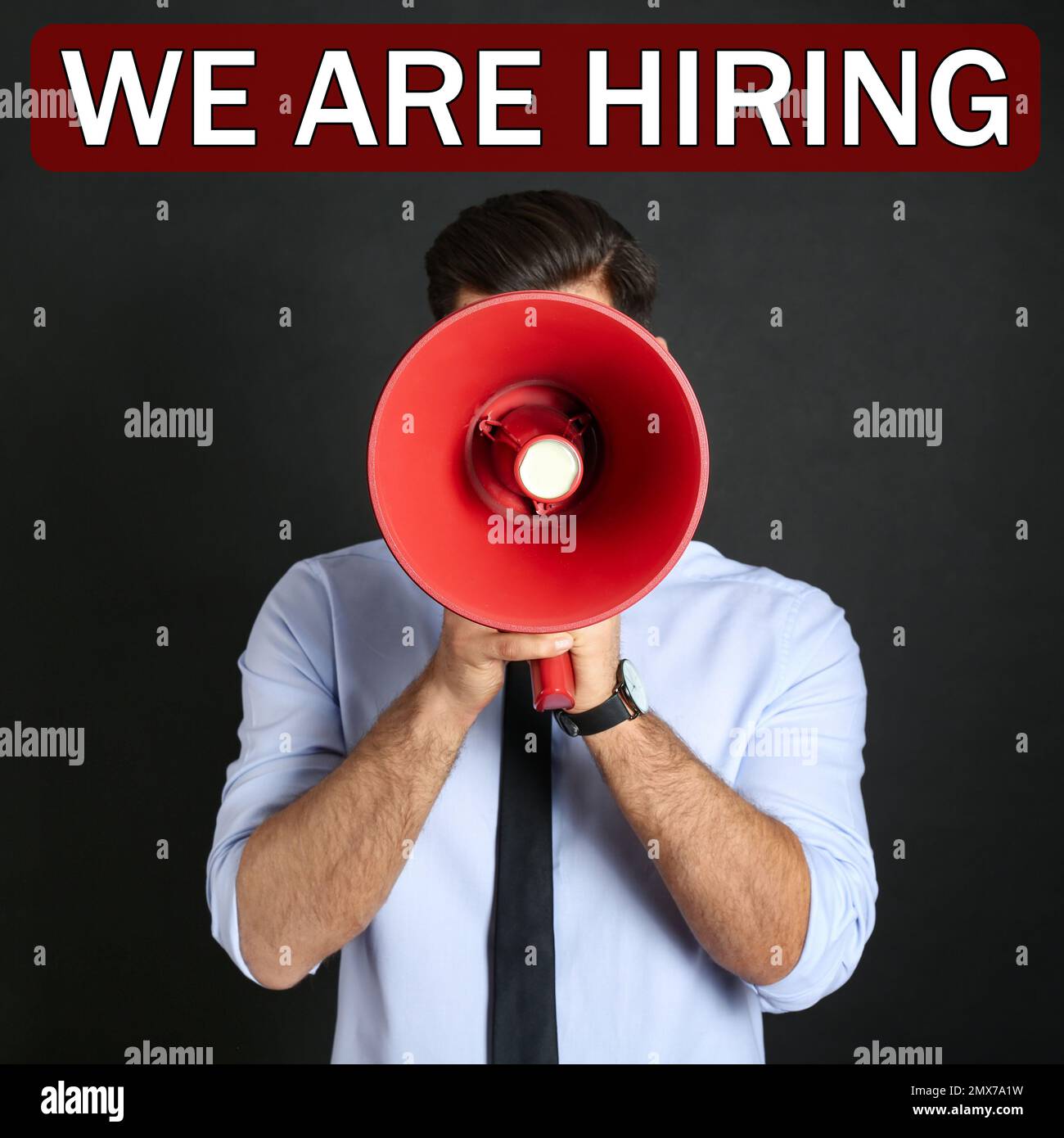 Man with megaphone and phrase WE ARE HIRING on black background. Career ...
