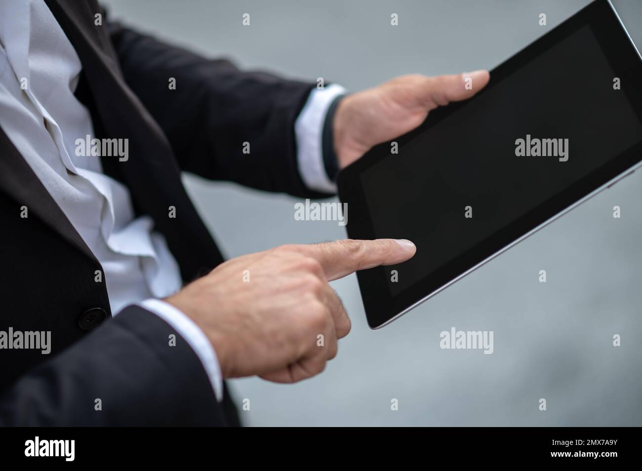 Close up of a mans hand touching the sensor screen of a tablet Stock ...