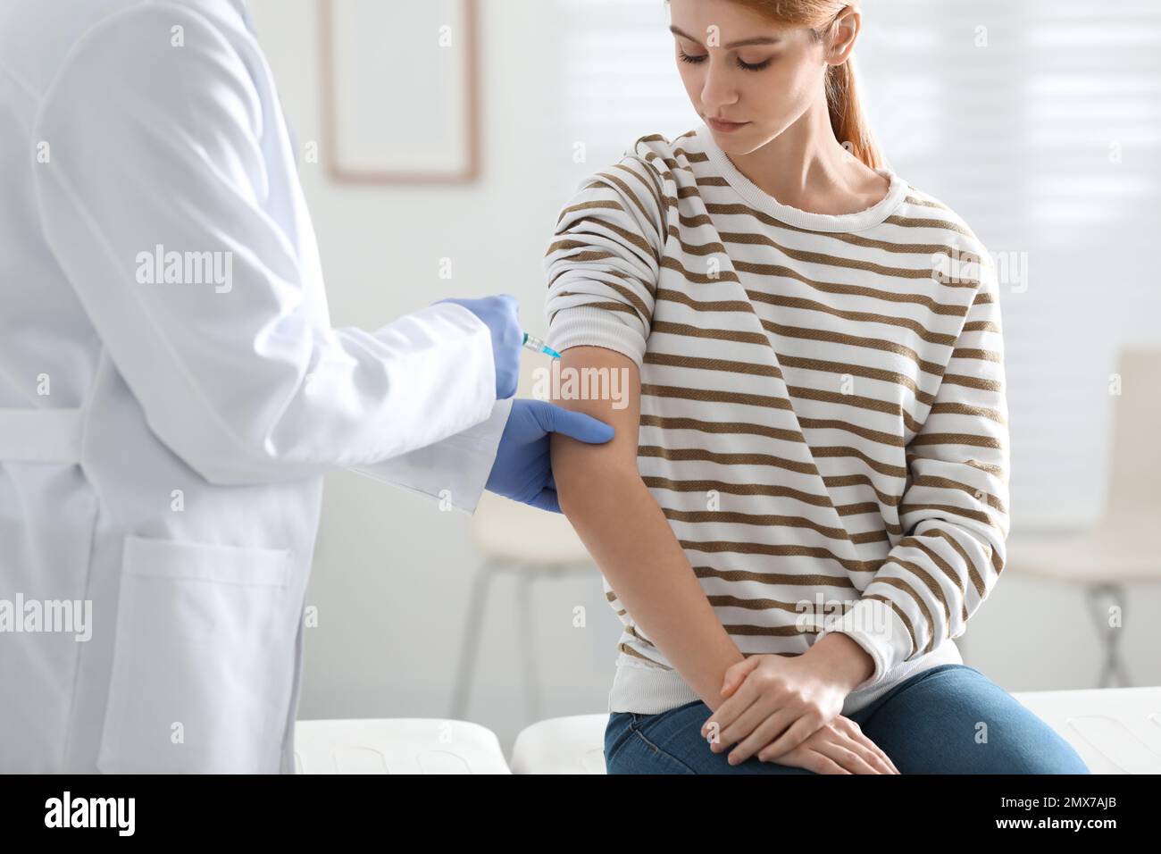Doctor giving injection to patient in hospital. Vaccination concept ...