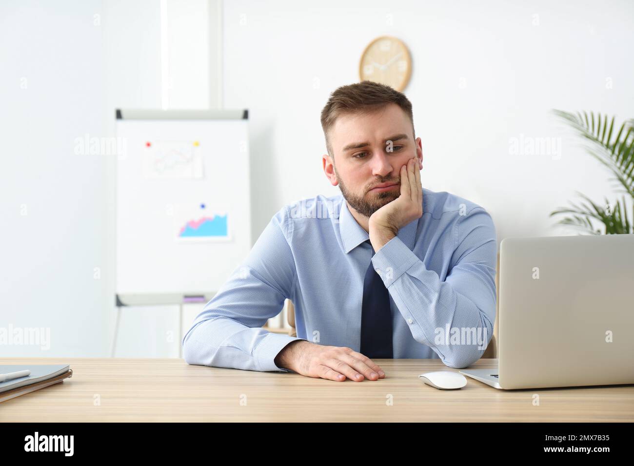 Lazy young office employee procrastinating at workplace Stock Photo - Alamy