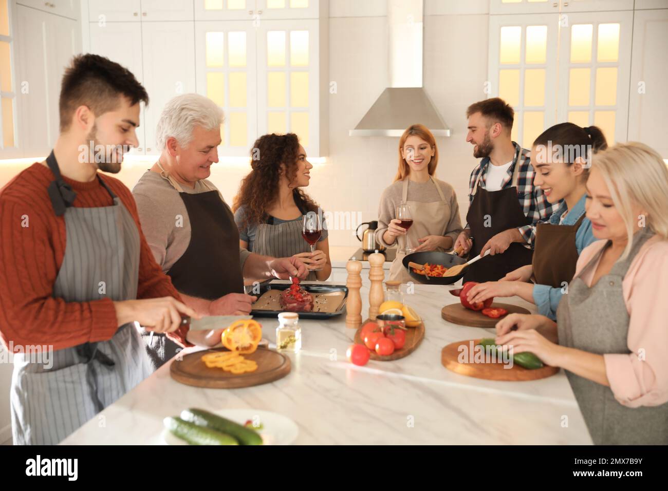 Happy people cooking food together in kitchen Stock Photo - Alamy