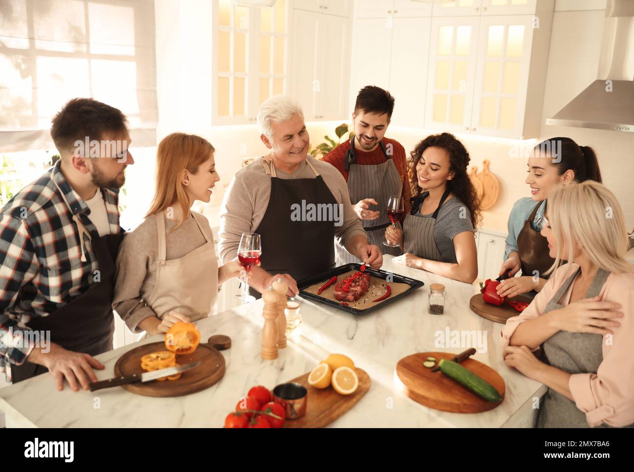 Happy people cooking food together in kitchen Stock Photo - Alamy