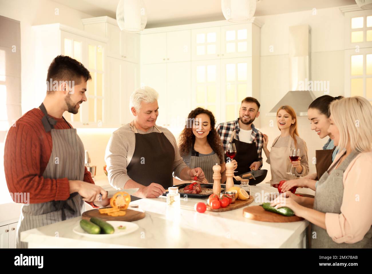 Happy people cooking food together in kitchen Stock Photo - Alamy