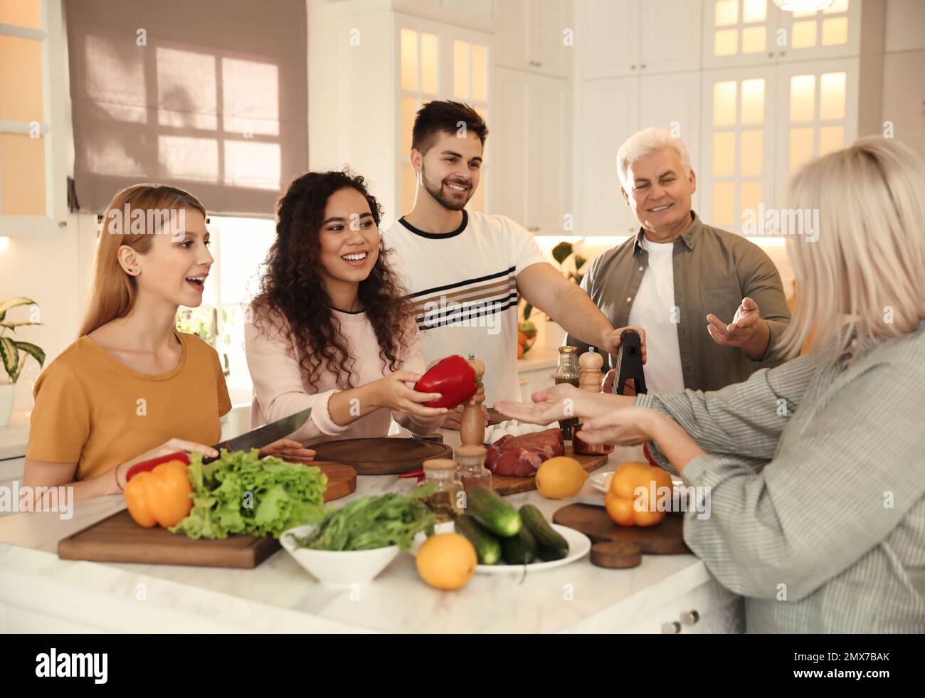 Happy people cooking food together in kitchen Stock Photo - Alamy