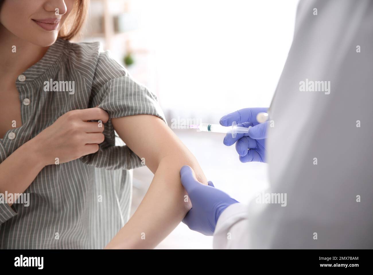 Doctor giving injection to patient in hospital, closeup. Vaccination ...